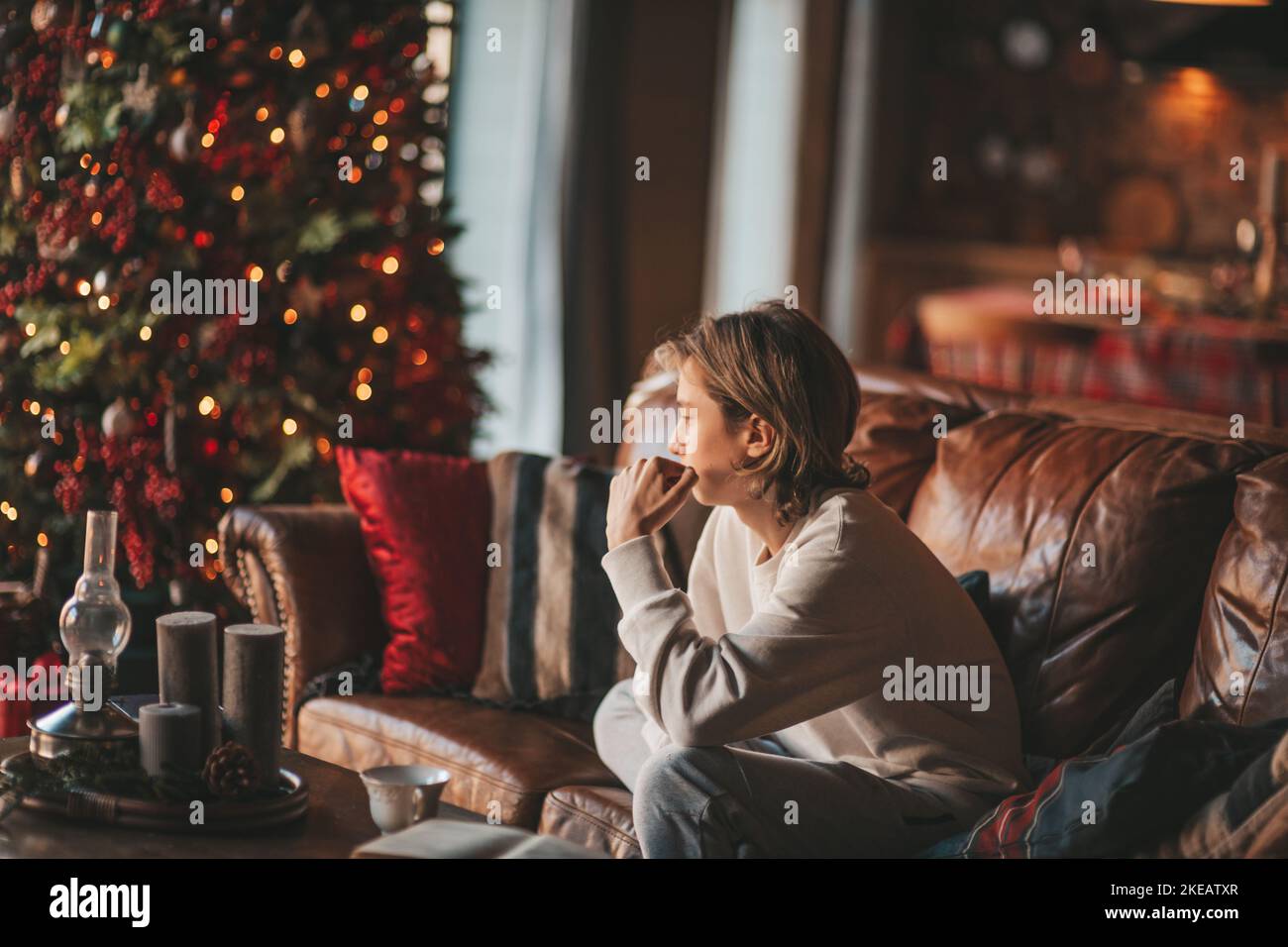 Young teen boy with long hair thoughtful look sad eyes negative mood ...