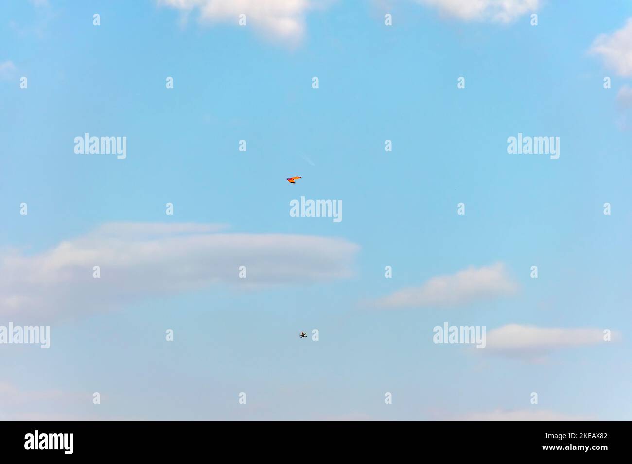 A quadcopter drone and a remote-controlled aircraft drone UAV flying ...