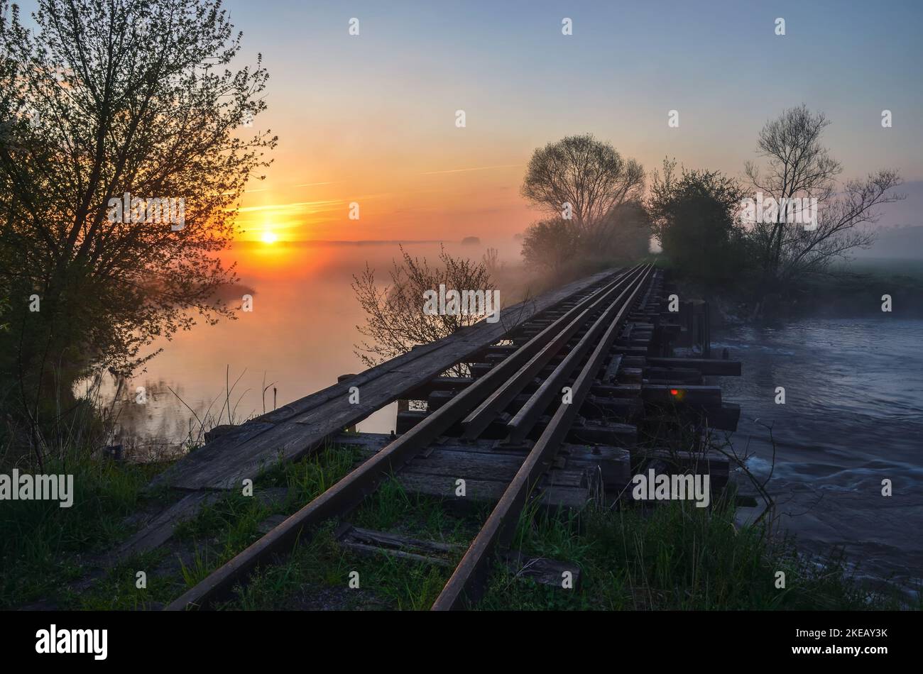Beautiful summer morning. Bridge with rails at a lovely sunrise Stock ...