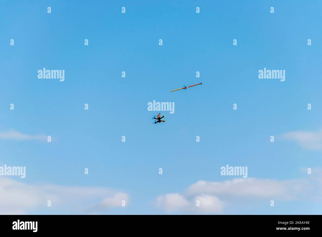 A quadcopter drone and a remote-controlled aircraft drone UAV flying ...