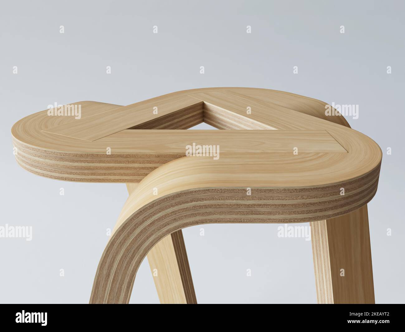 A wooden side table made from three curvy interlocking parts on an ...