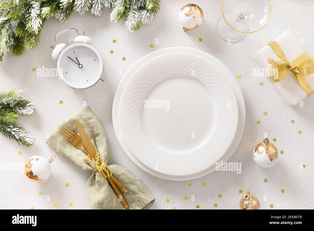 Beautiful Christmas festive table setting with white clock, gift ...