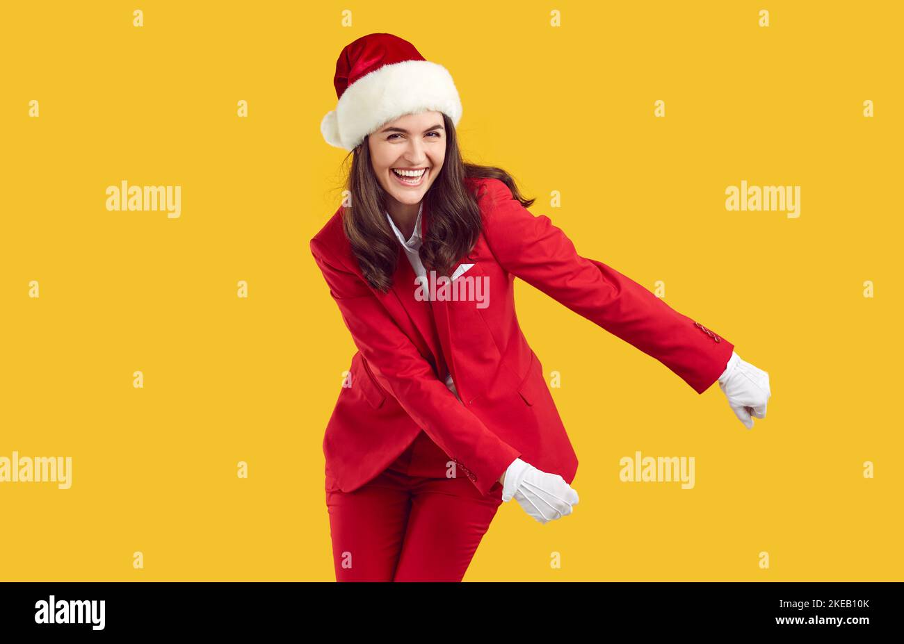 Laughing cheerful woman wearing Santa style dancing swish backpack ...