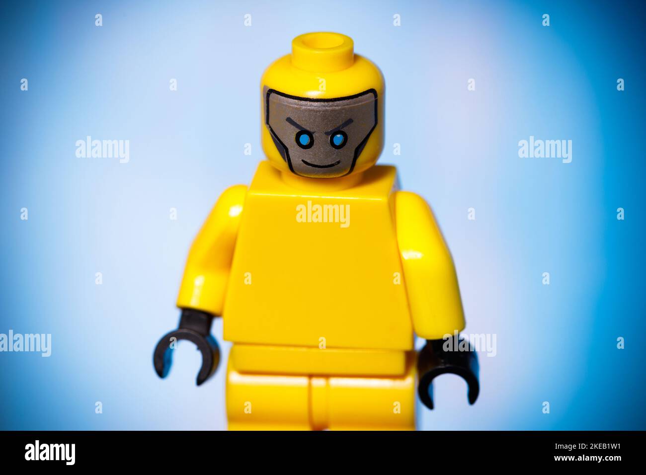 yellow lego figure with an evil face on a blue background with a ...
