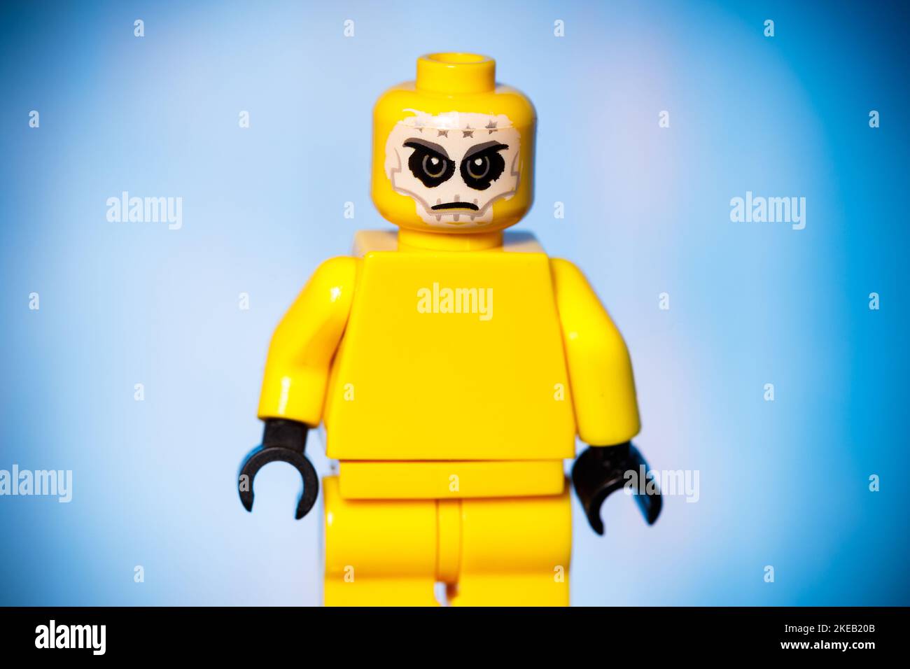 yellow lego figure with a sarcastic face on a blue background. High ...