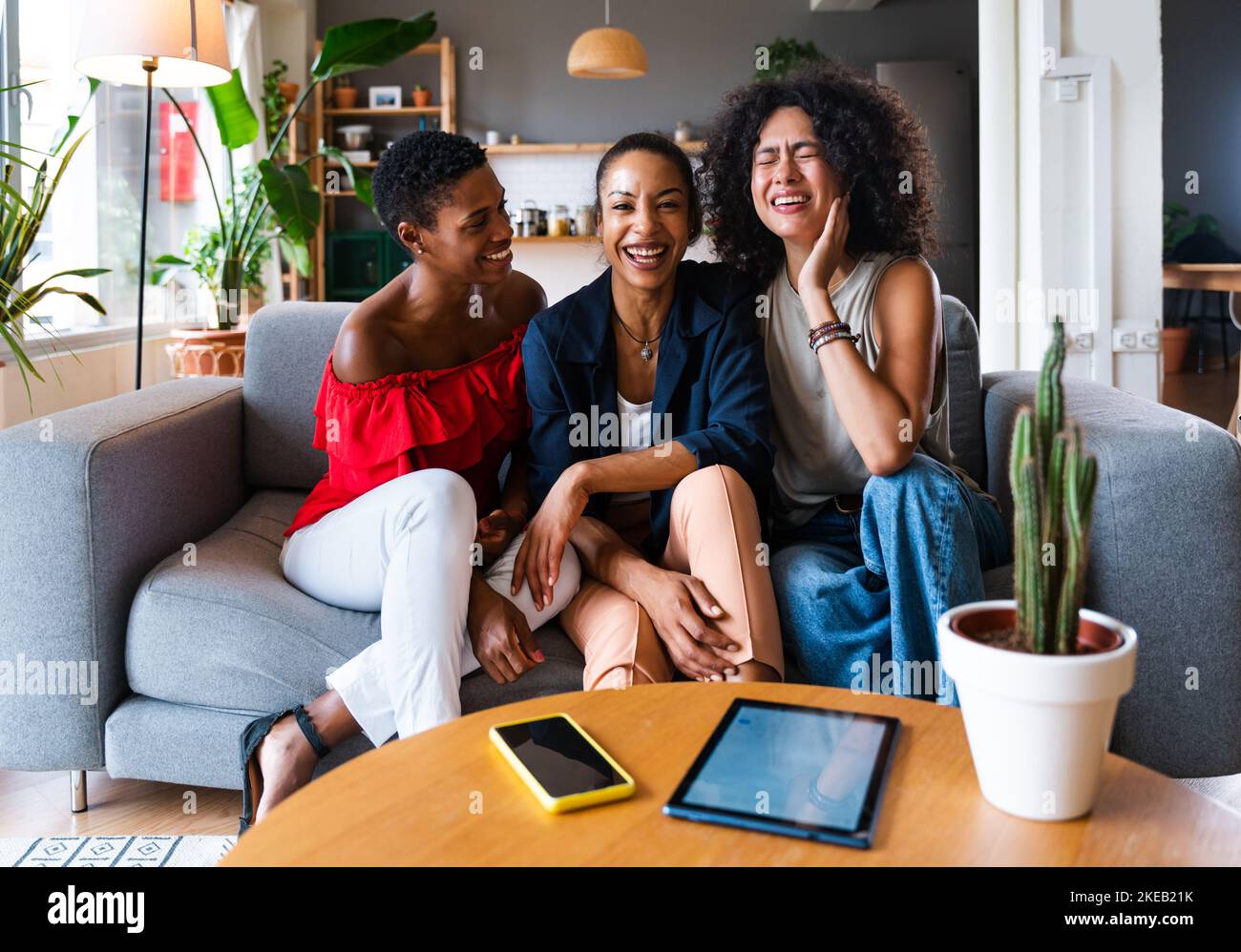 Happy beautiful hispanic south american and black women meeting indoors ...