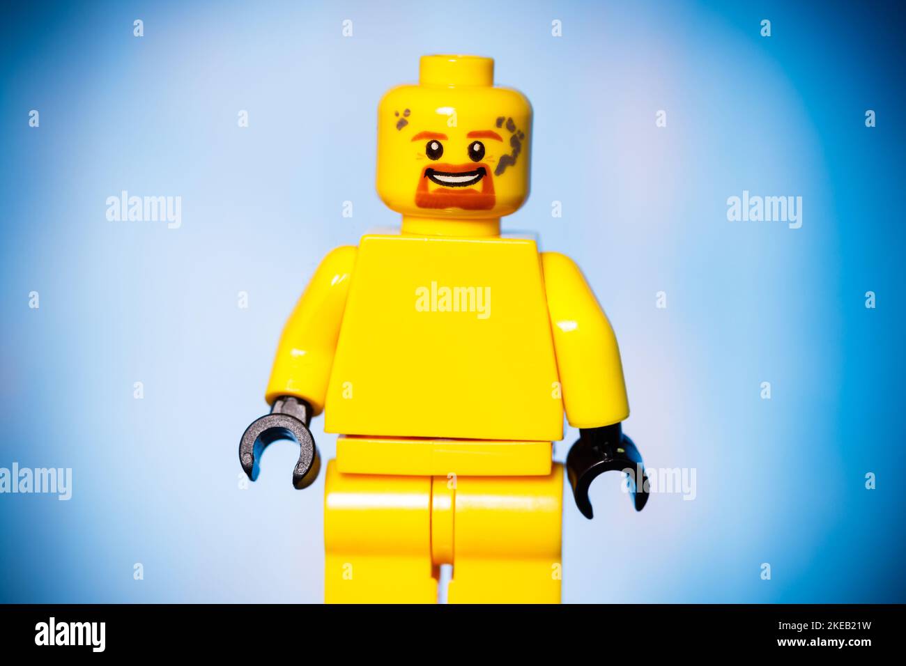 yellow lego figure with a smile on his face on a blue background with a ...