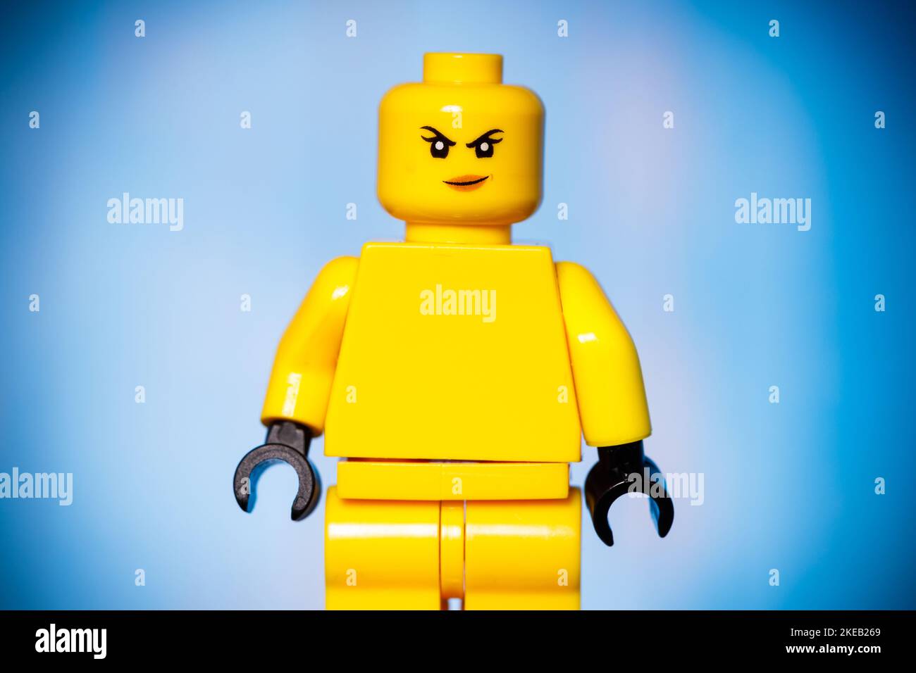 yellow lego figure with an evil face on a blue background. High quality ...