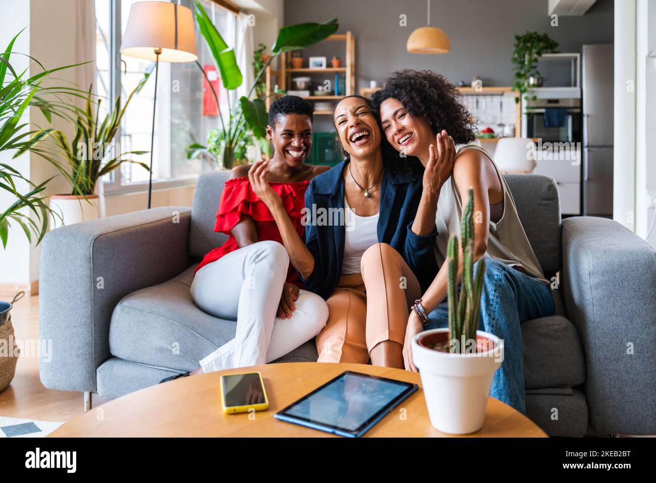 Happy beautiful hispanic south american and black women meeting indoors ...