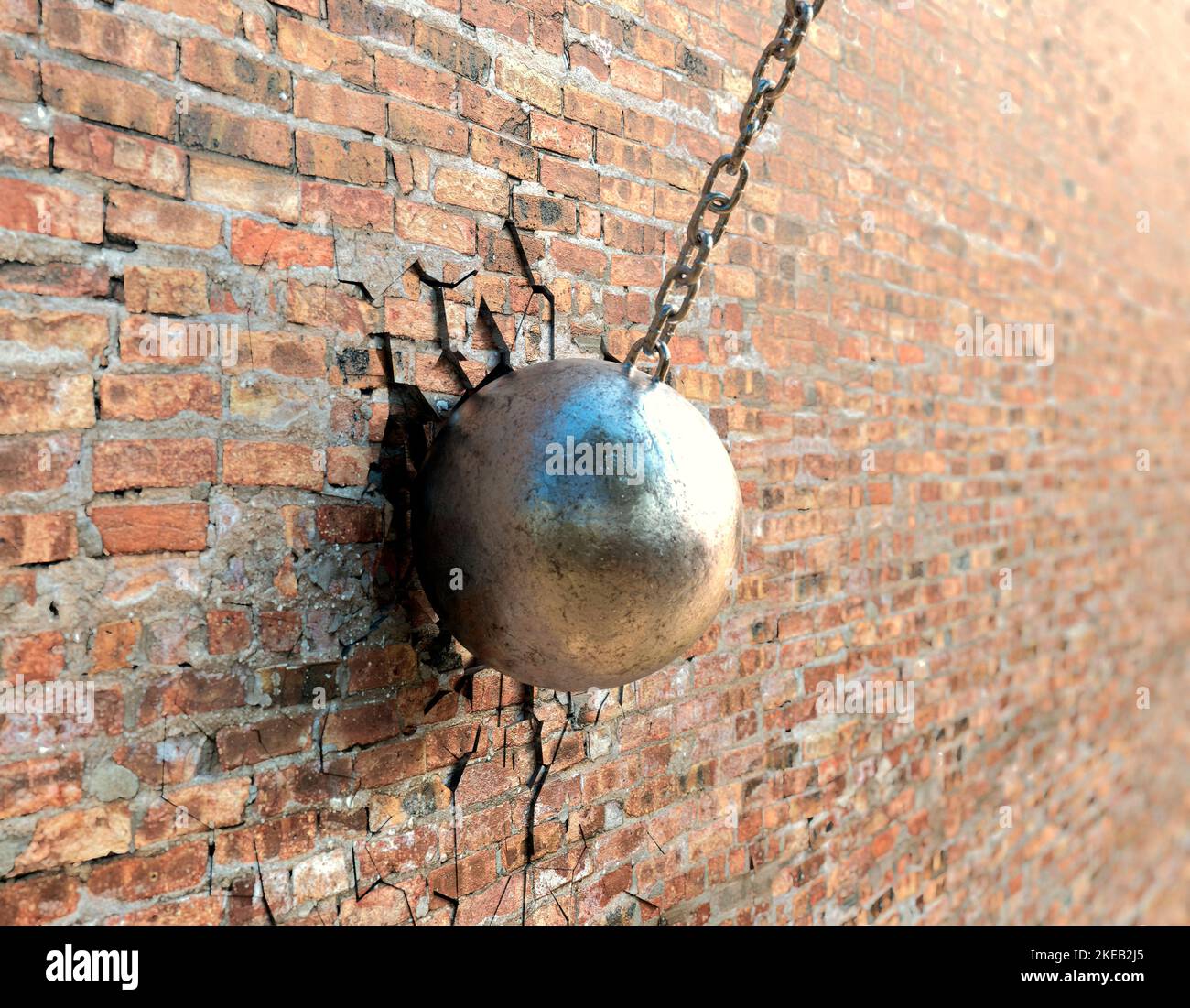 A regular metal wrecking ball attached to a chain breaking a hole in a ...