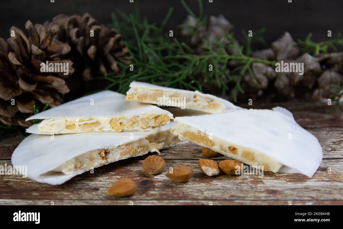 almond nougat with christmas decorations on rustic wood Stock Photo - Alamy