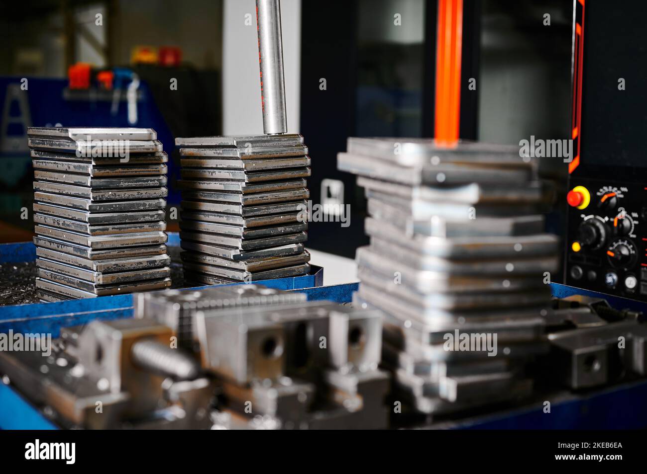Stacks of silver metal plates on tray at production plant Stock Photo ...