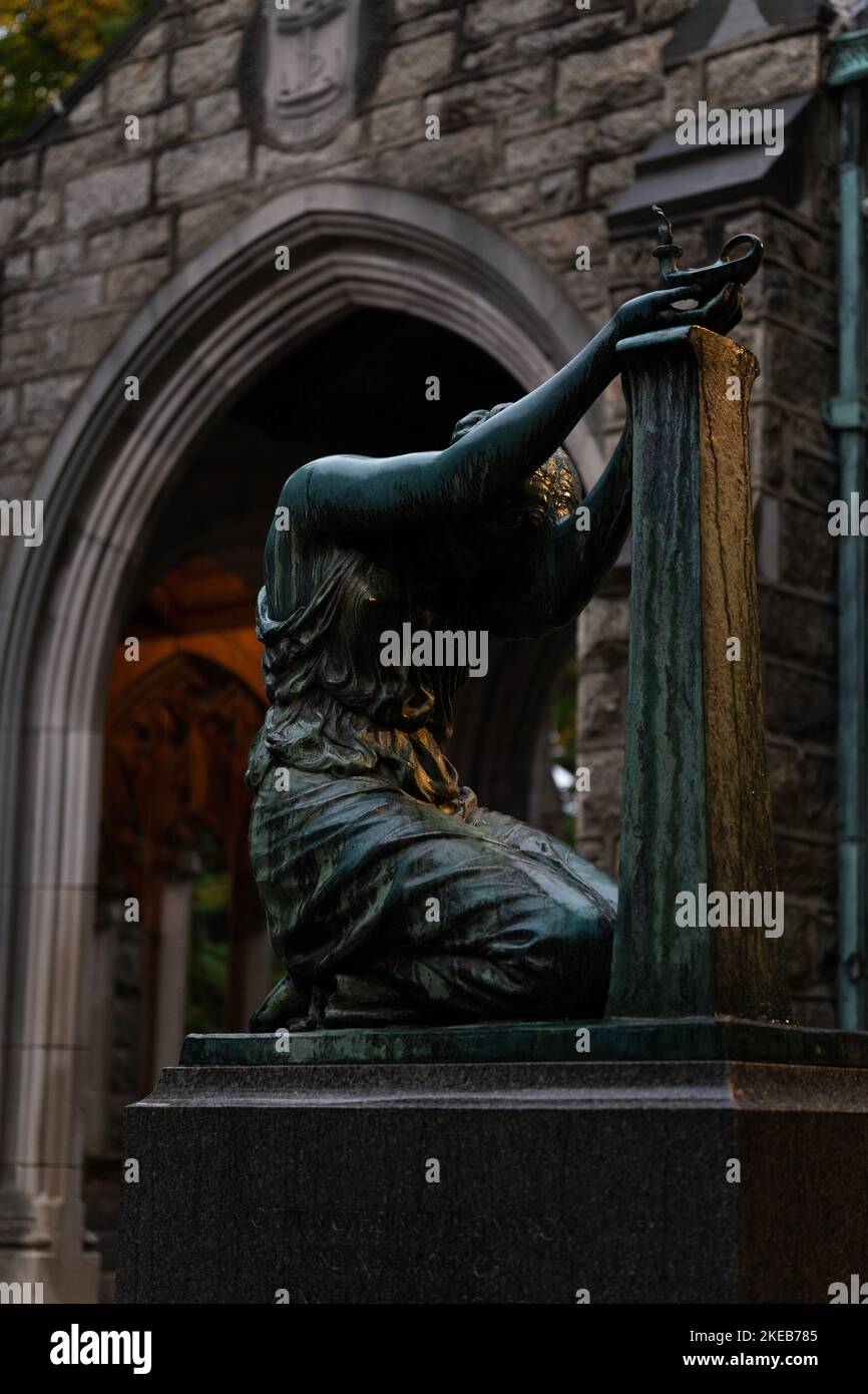 statue of a woman in a courtyard Stock Photo - Alamy