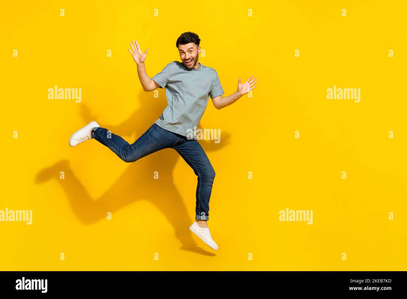 Full body portrait of satisfied glad person jumping raise hands empty ...