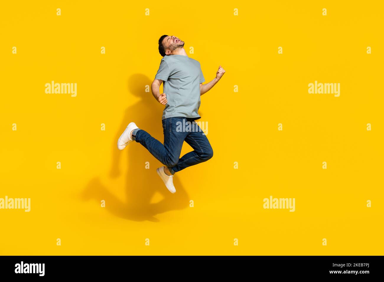 Full body photo of satisfied glad person jumping raise fists scream yes ...