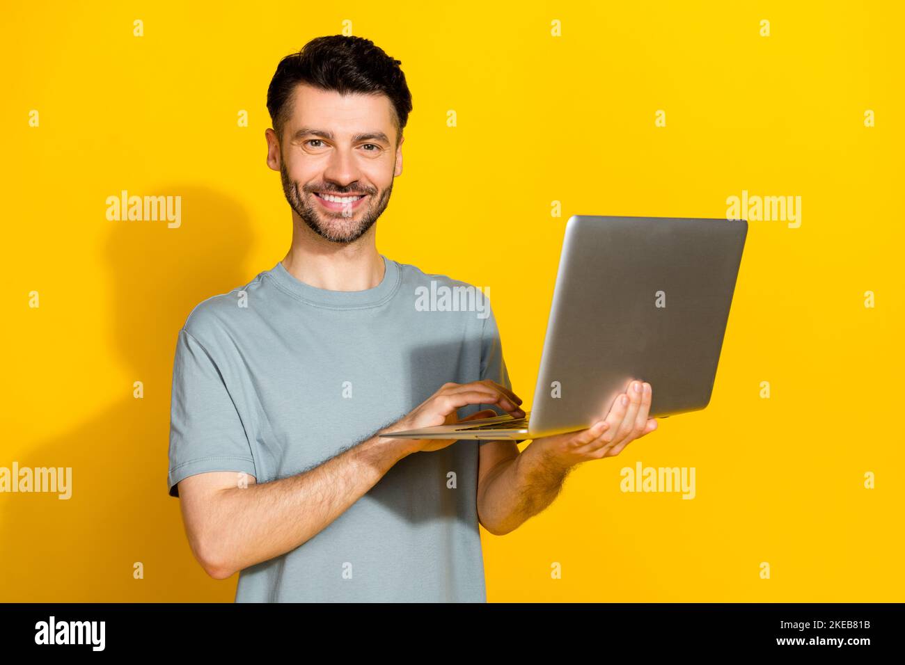 Photo of young confident professional coder programmer hold new laptop ...