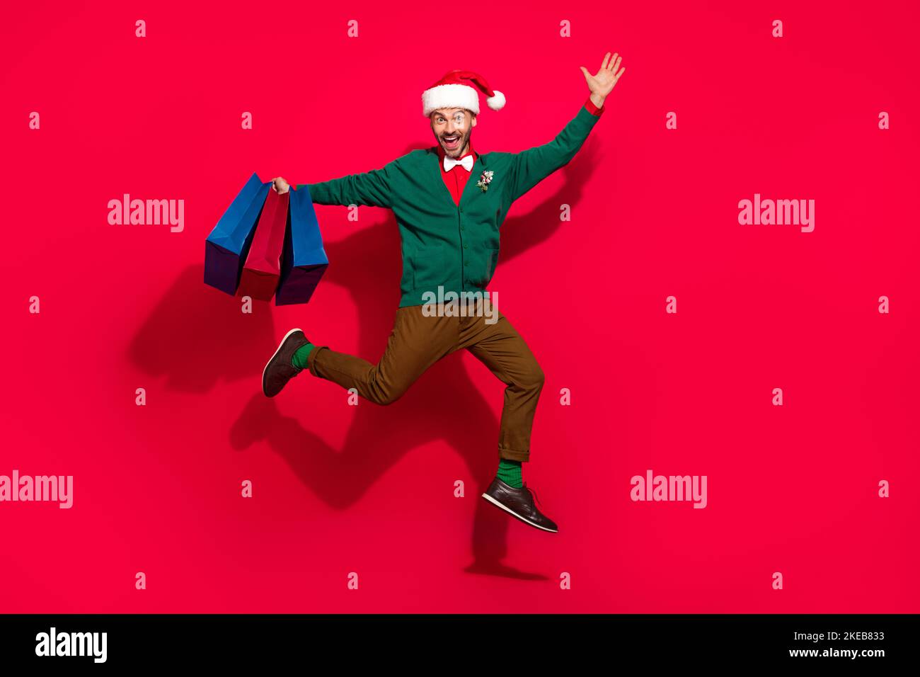 Full length photo of excited charming guy dressed xmas green cardigan ...