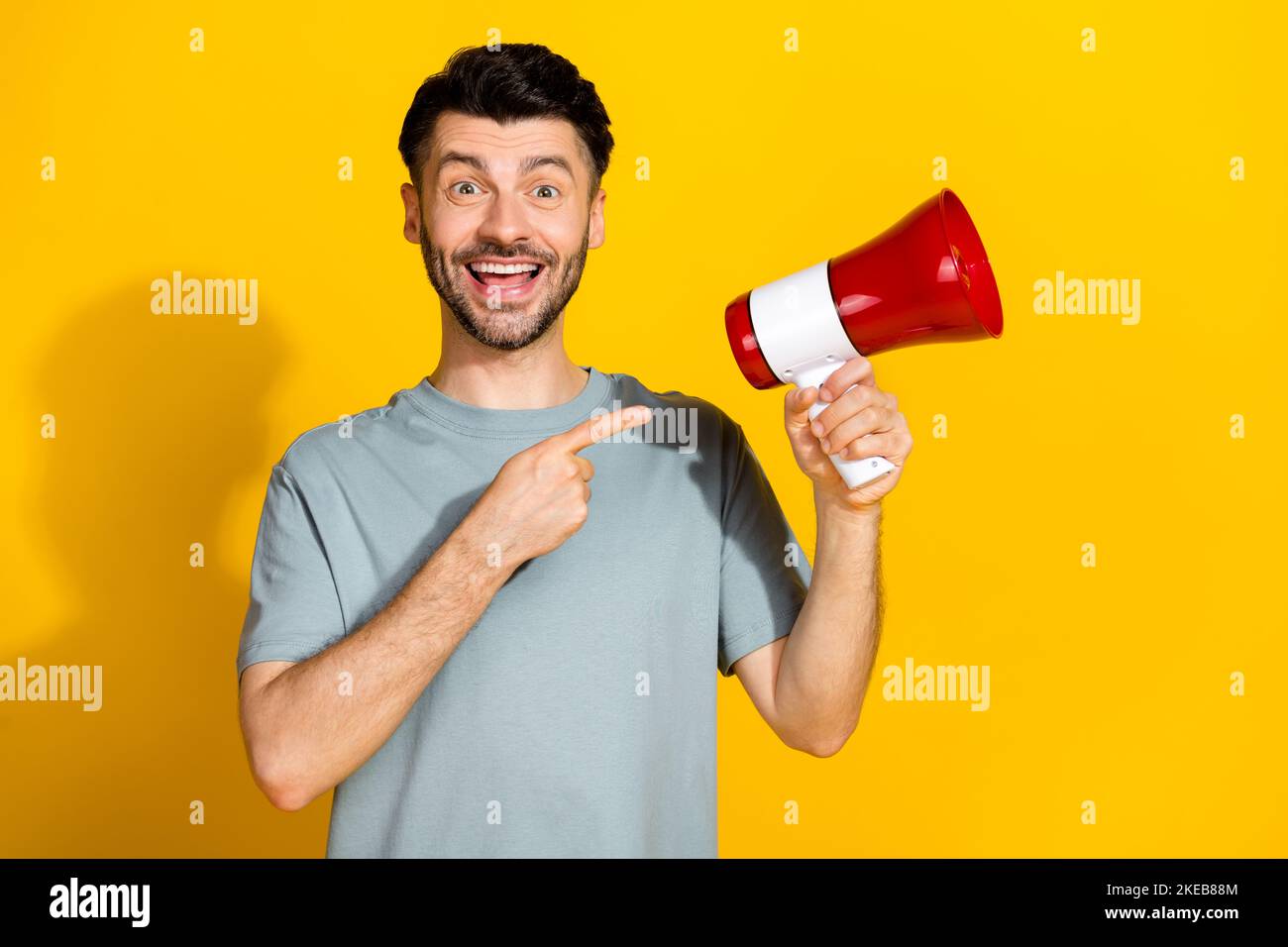 Photo of cheerful positive man arm direct empty space recommend ...