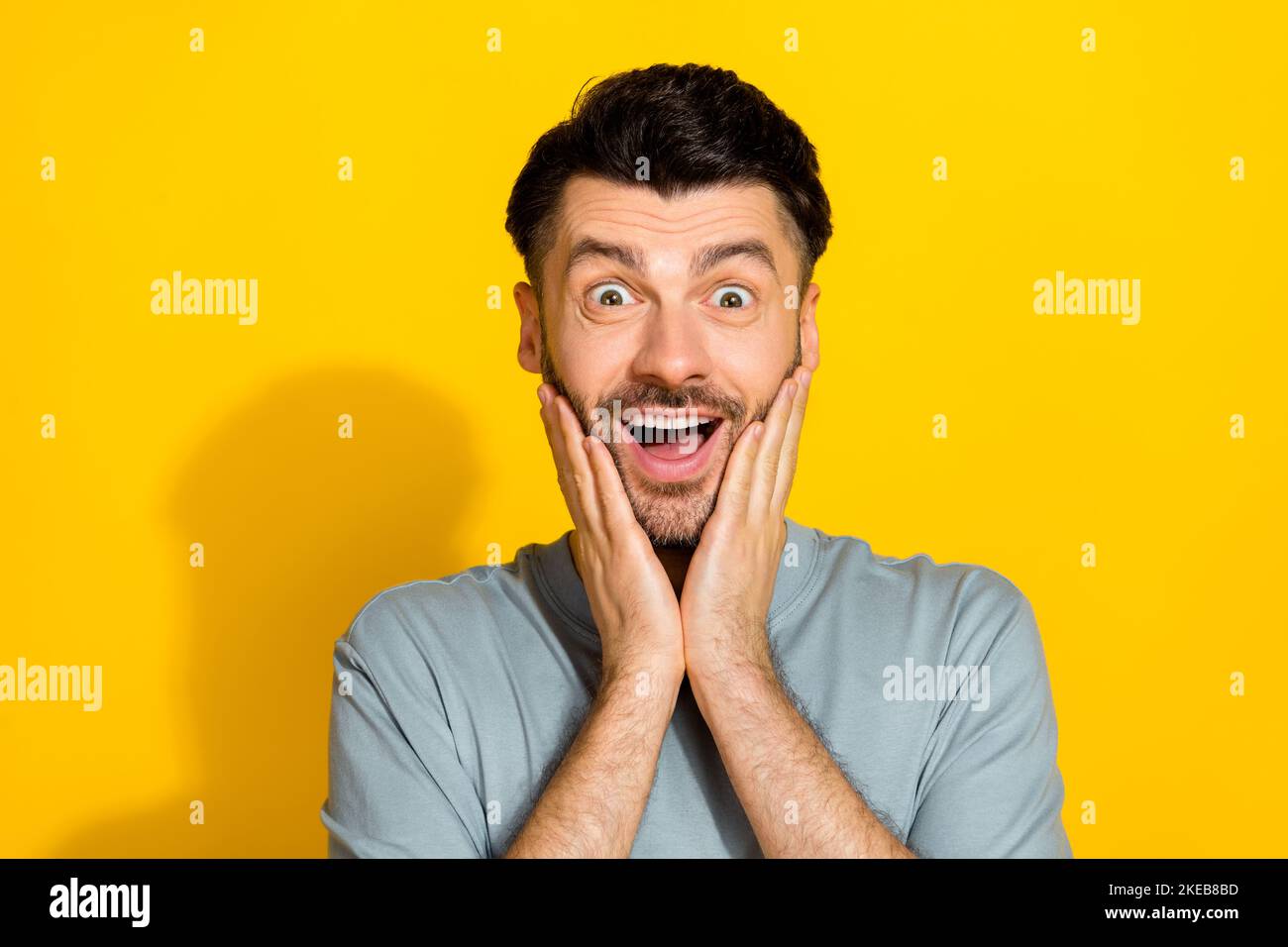 Closeup photo of young excited funky man touch cheeks shocked how low ...