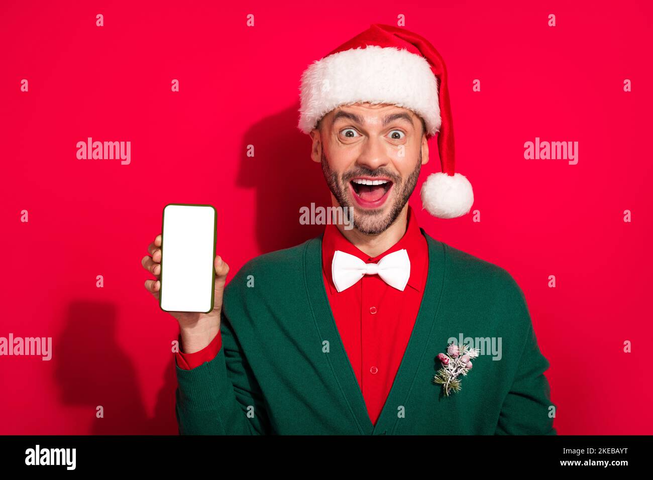 Photo of handsome impressed guy dressed xmas green cardigan bowtie ...