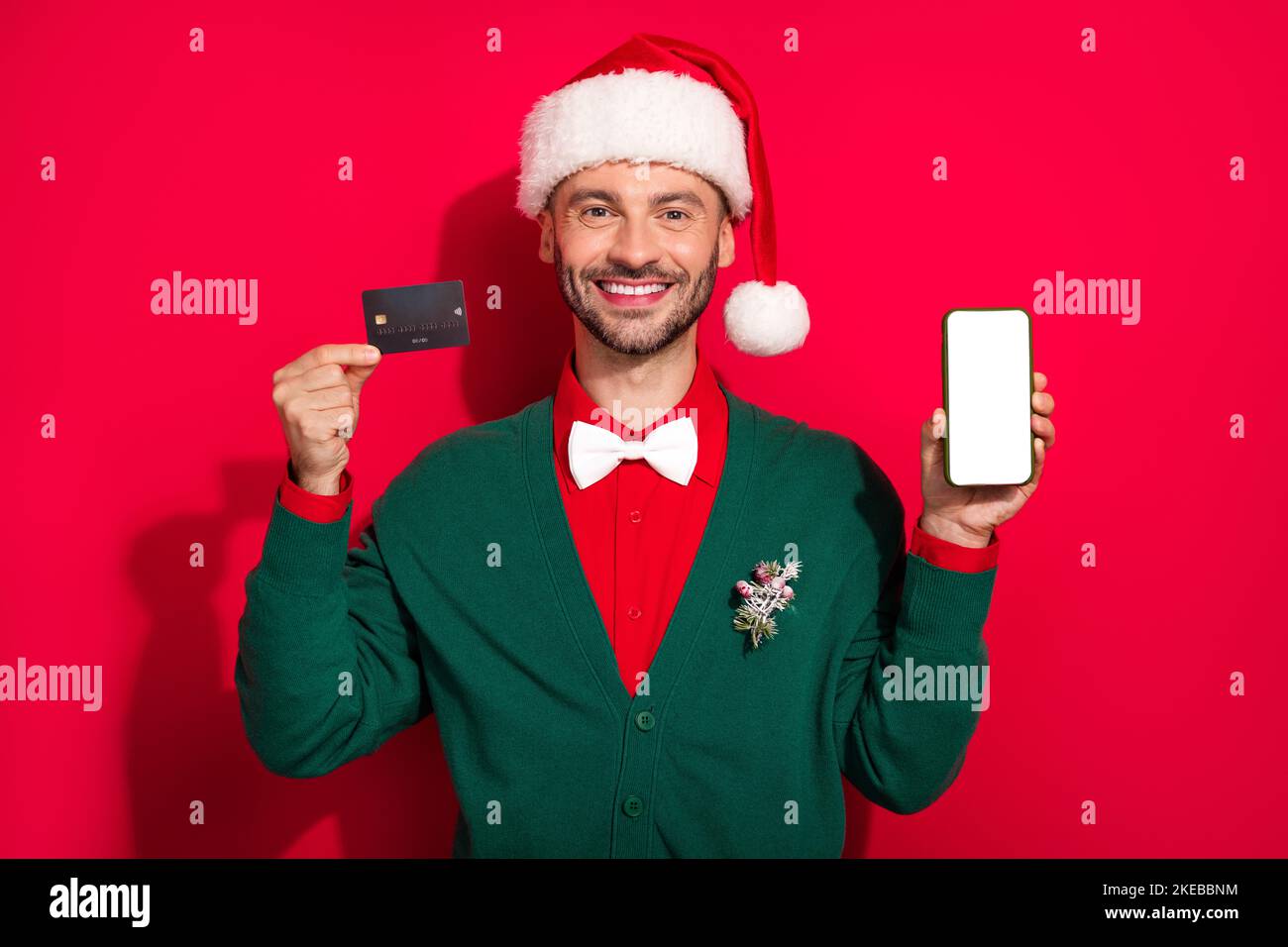 Photo of funny sweet guy dressed xmas green cardigan bowtie rising bank ...