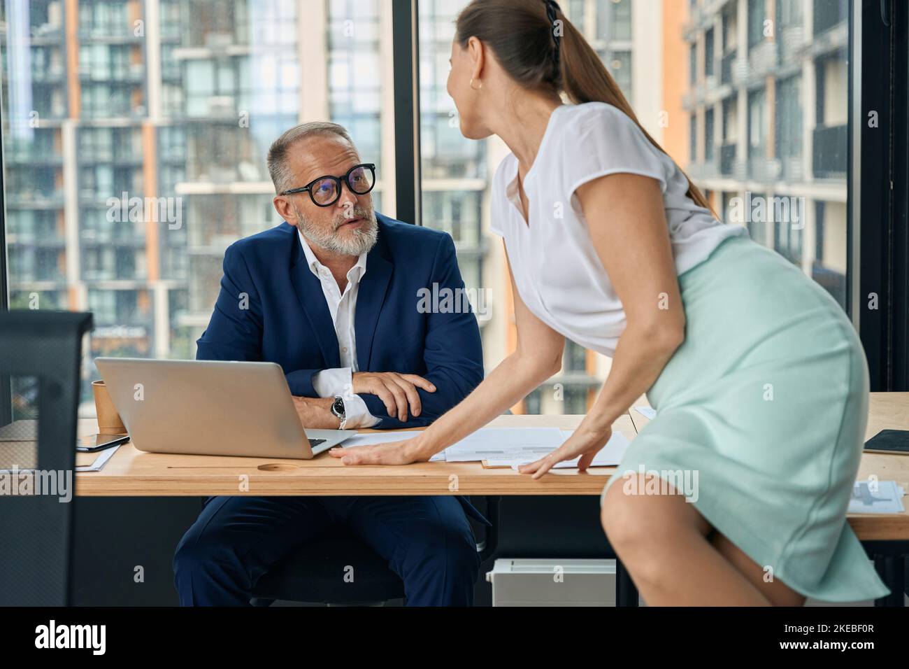 Woman flirting with male boss in office during working day Stock Photo ...