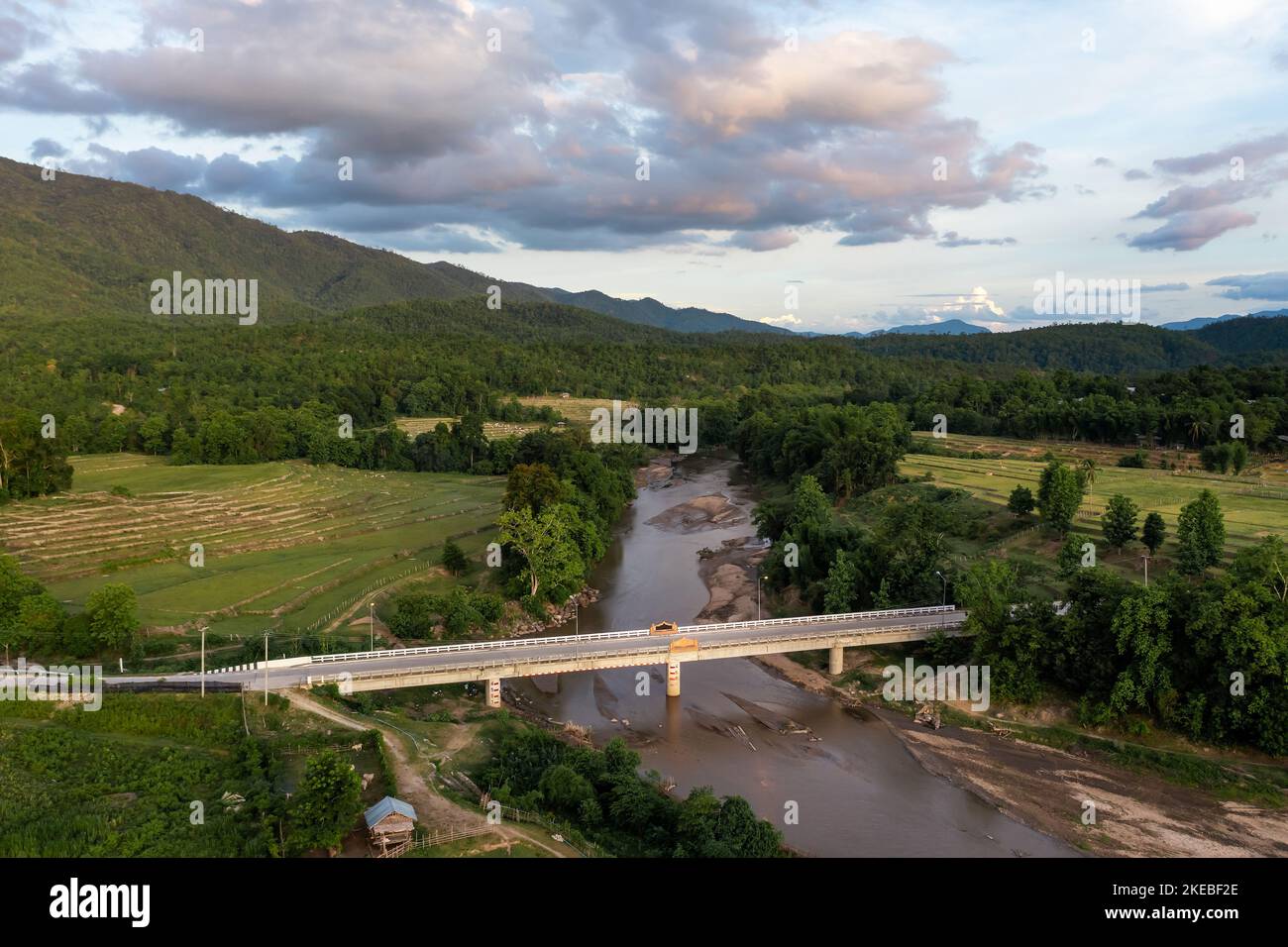 A concrete bridge over the river is surrounded by forest river and ...