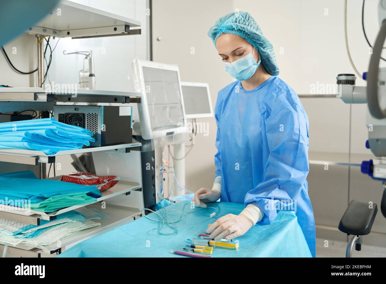 Medical worker preparing equipment for surgery in hospital Stock Photo ...