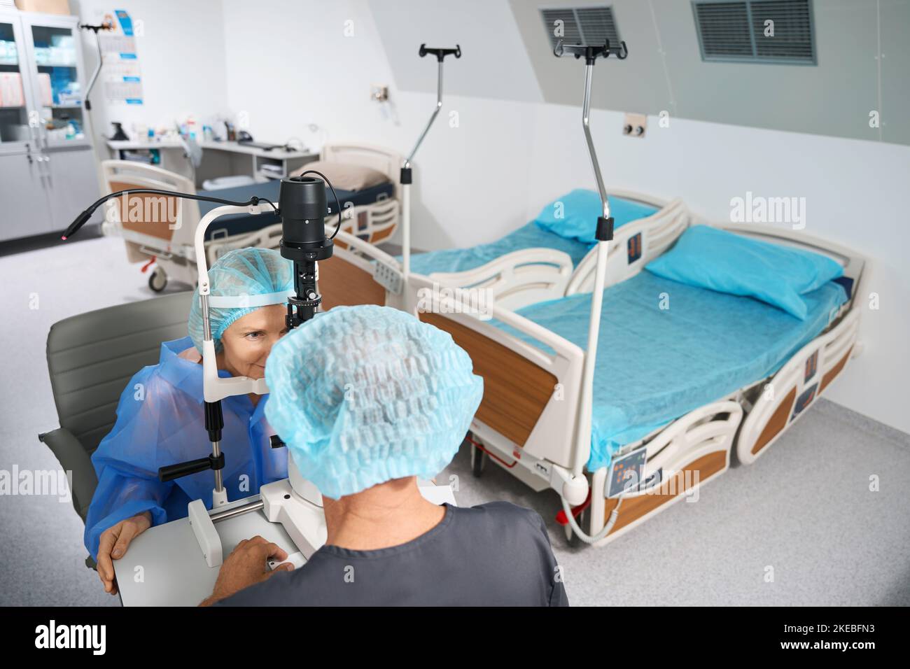 Ophthalmologist examining the eyeball of patient after surgery Stock ...
