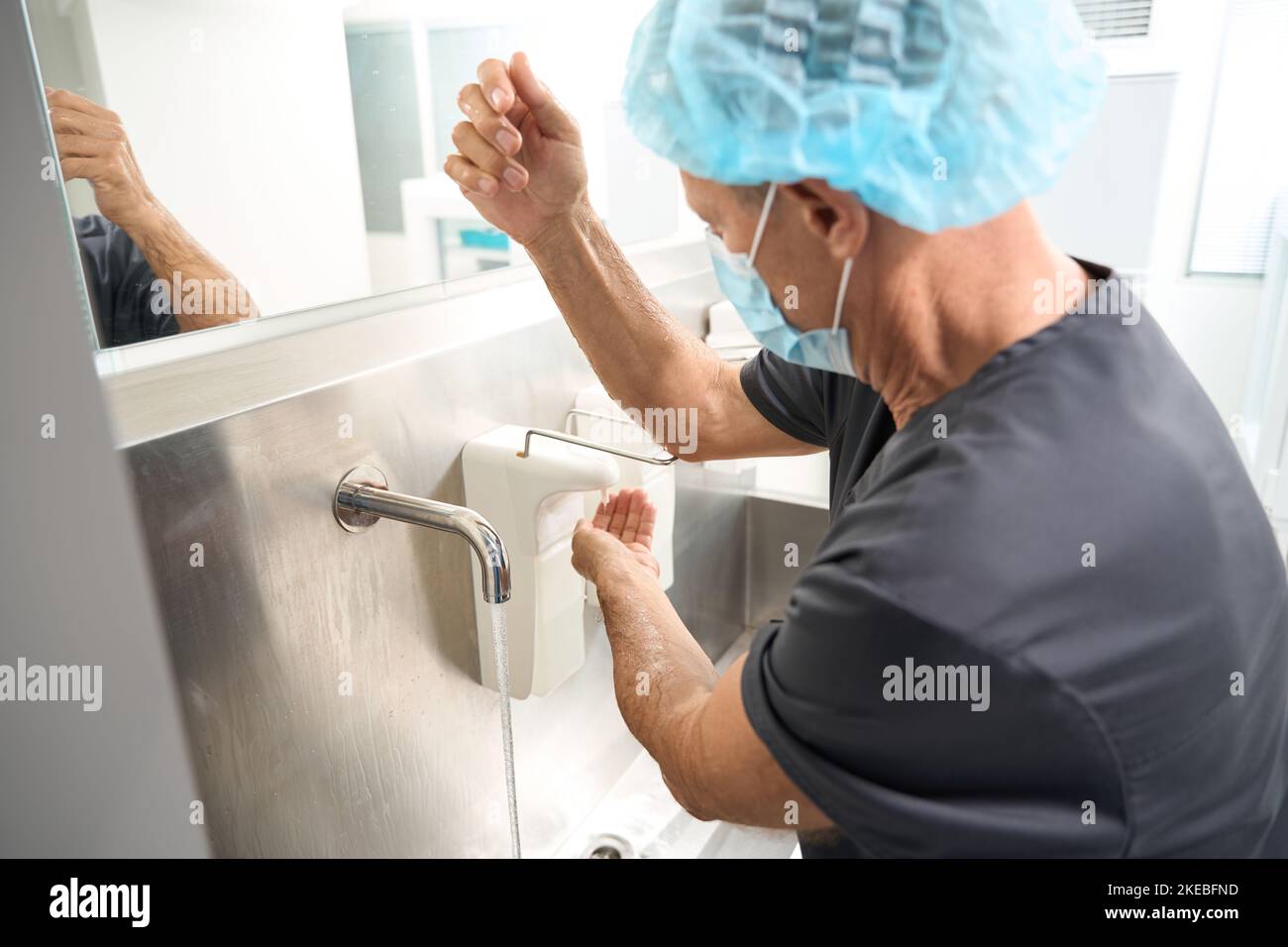 Medical worker cleaning hands before operation in hospital Stock Photo ...