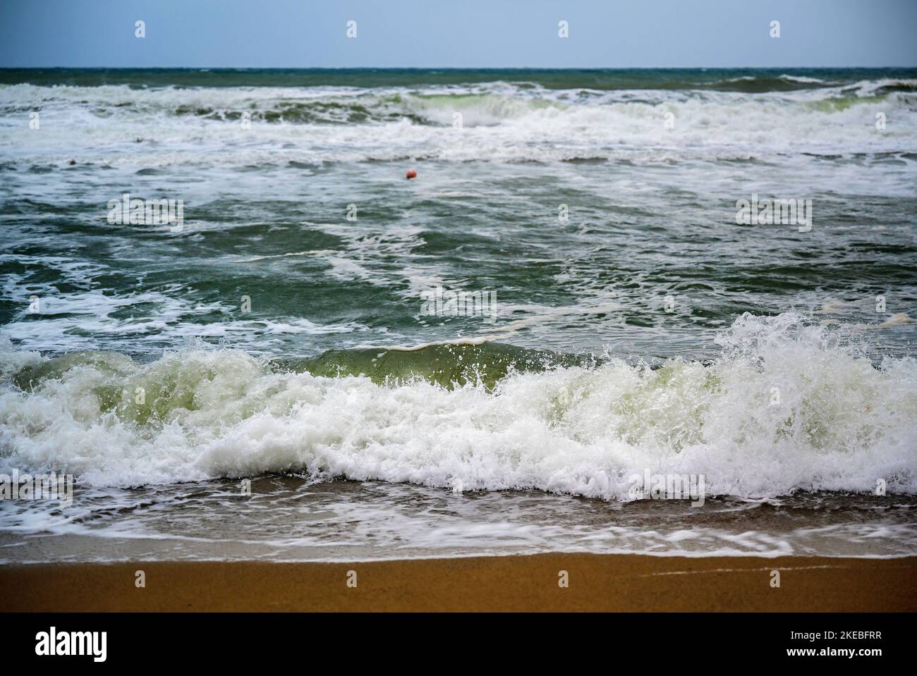 Stormy sea, big surf and wave in windy weather on sand beach, small ...