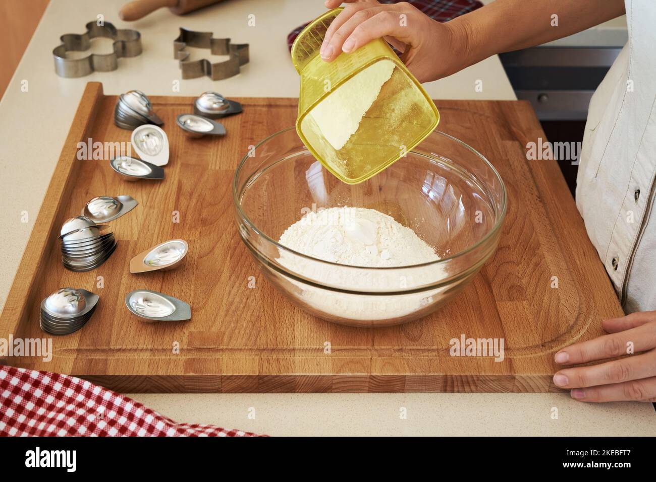 Preparation of homemade Christmas cookies - pouring ingredients for the ...
