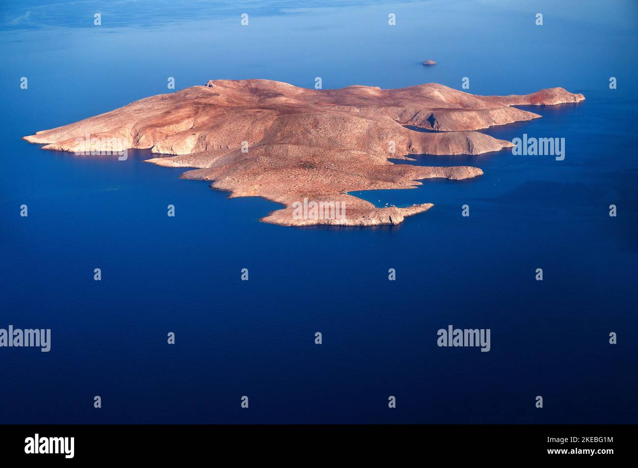 Aerial view to silhouette of Dia island in blue sea water near ...
