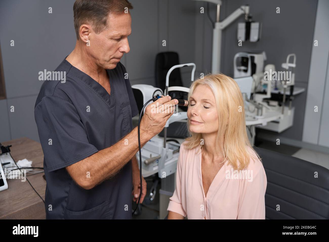 Lady undergoing eye test diagnostics in hospital Stock Photo - Alamy
