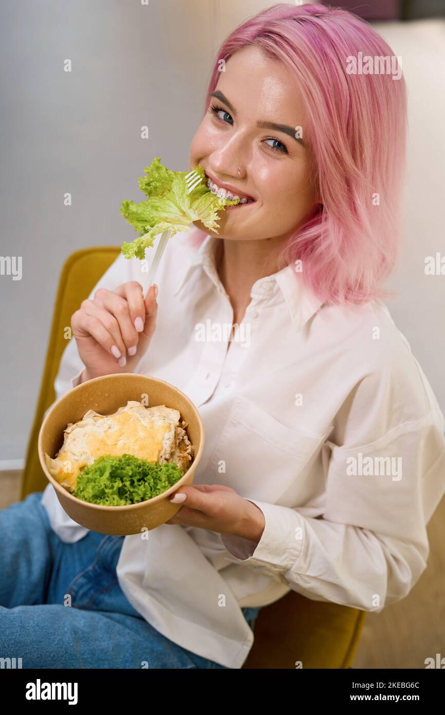 Happy lady having lunch and looking at the camera Stock Photo - Alamy
