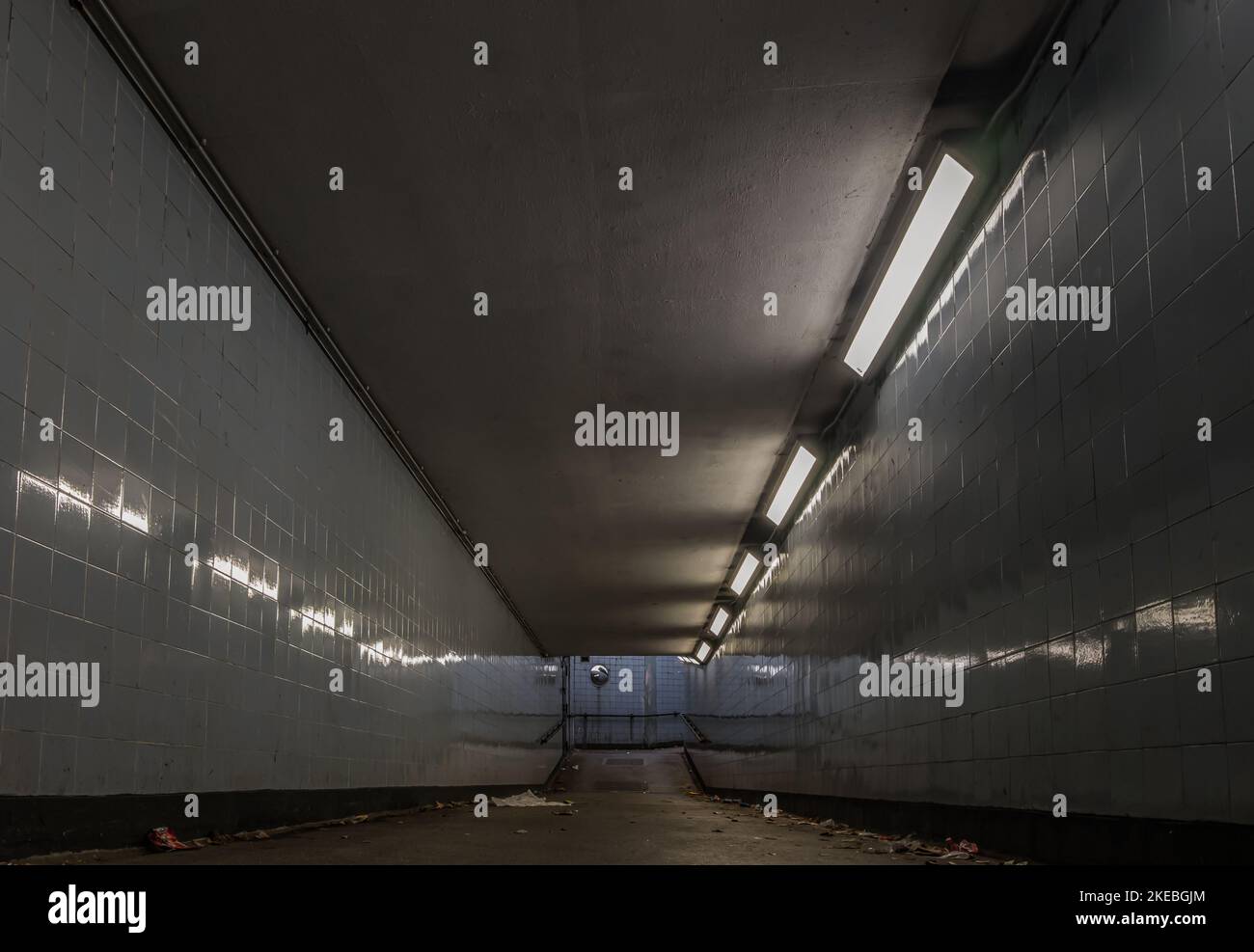 Perspective view of Ambient public underpass with white tiled walls and ...