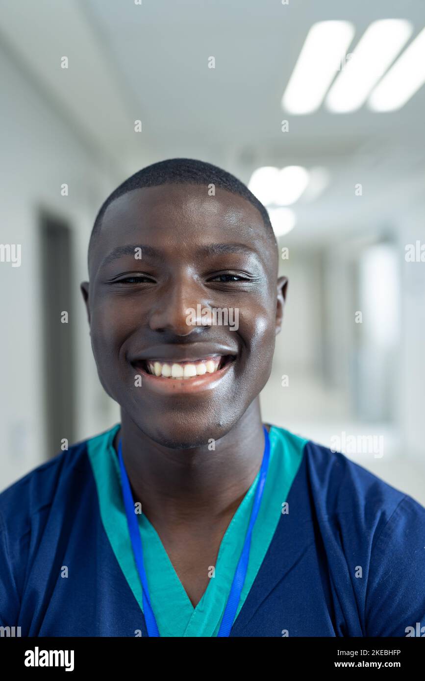 Vertical portrait of smiling african american male healthcare worker in ...
