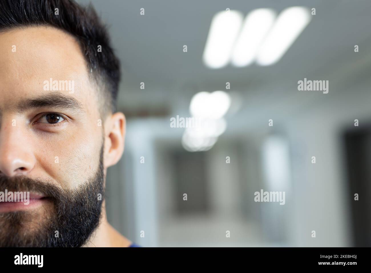 Portrait of half the face of caucasian male healthcare worker in ...