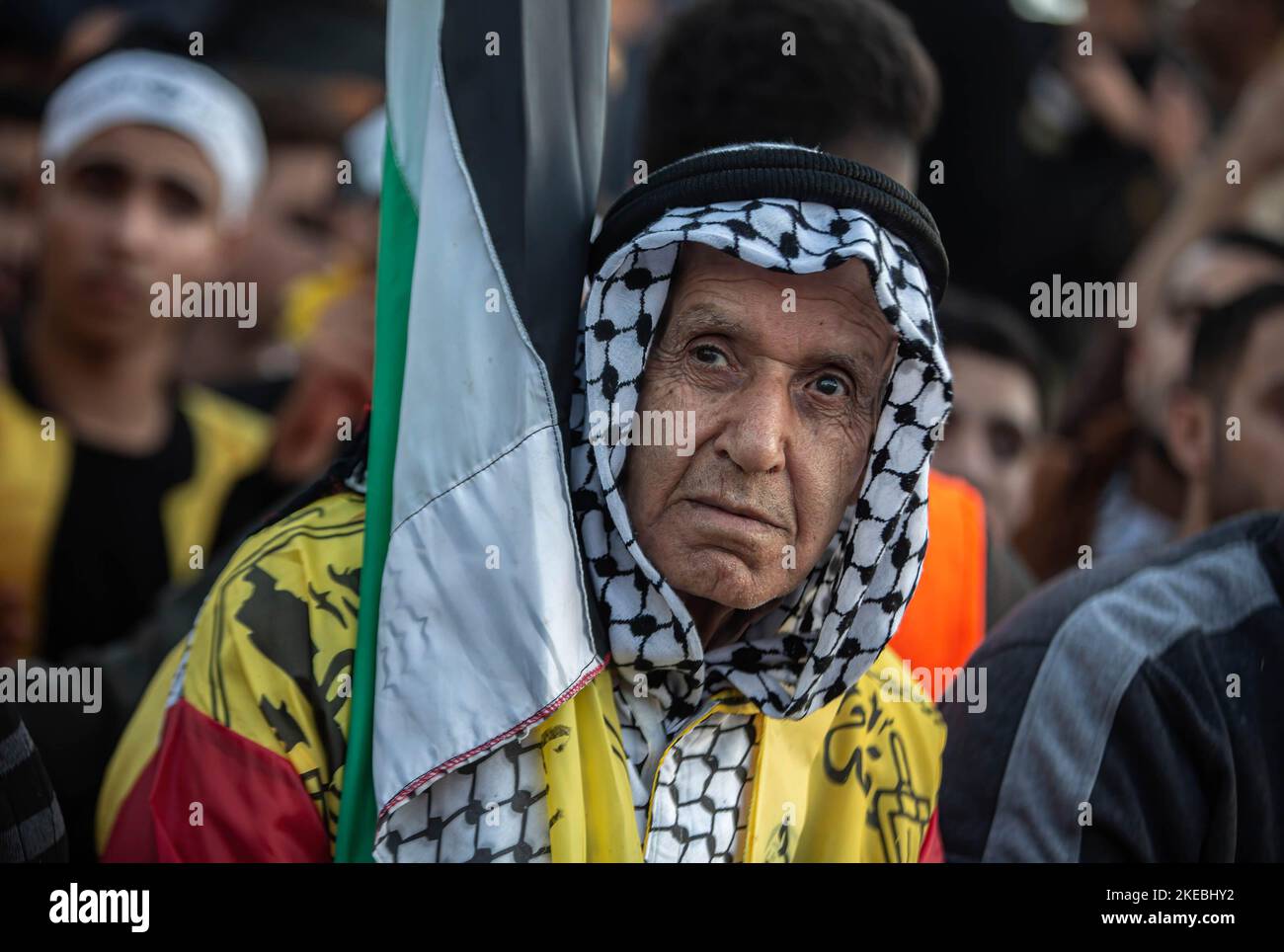 An elderly Palestinian man wears a keffiyeh on his head during a ...