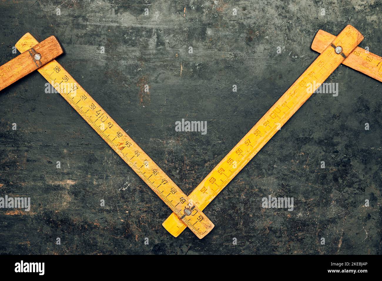 Wooden measure. Old ruler on metal surface. Measuring tool. Technical ...