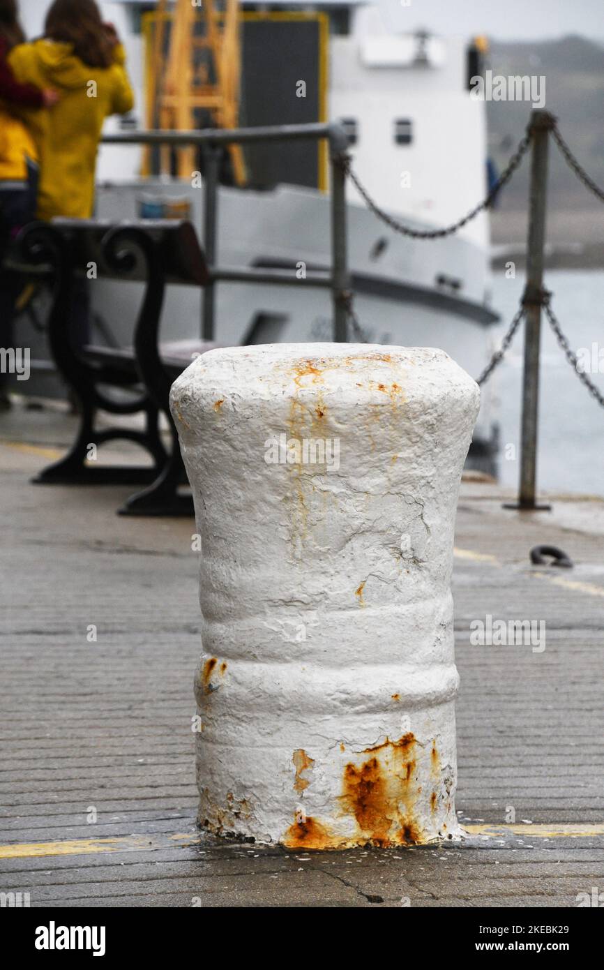 A bollard on the quay in the harbour at Hugh town on the island of St ...