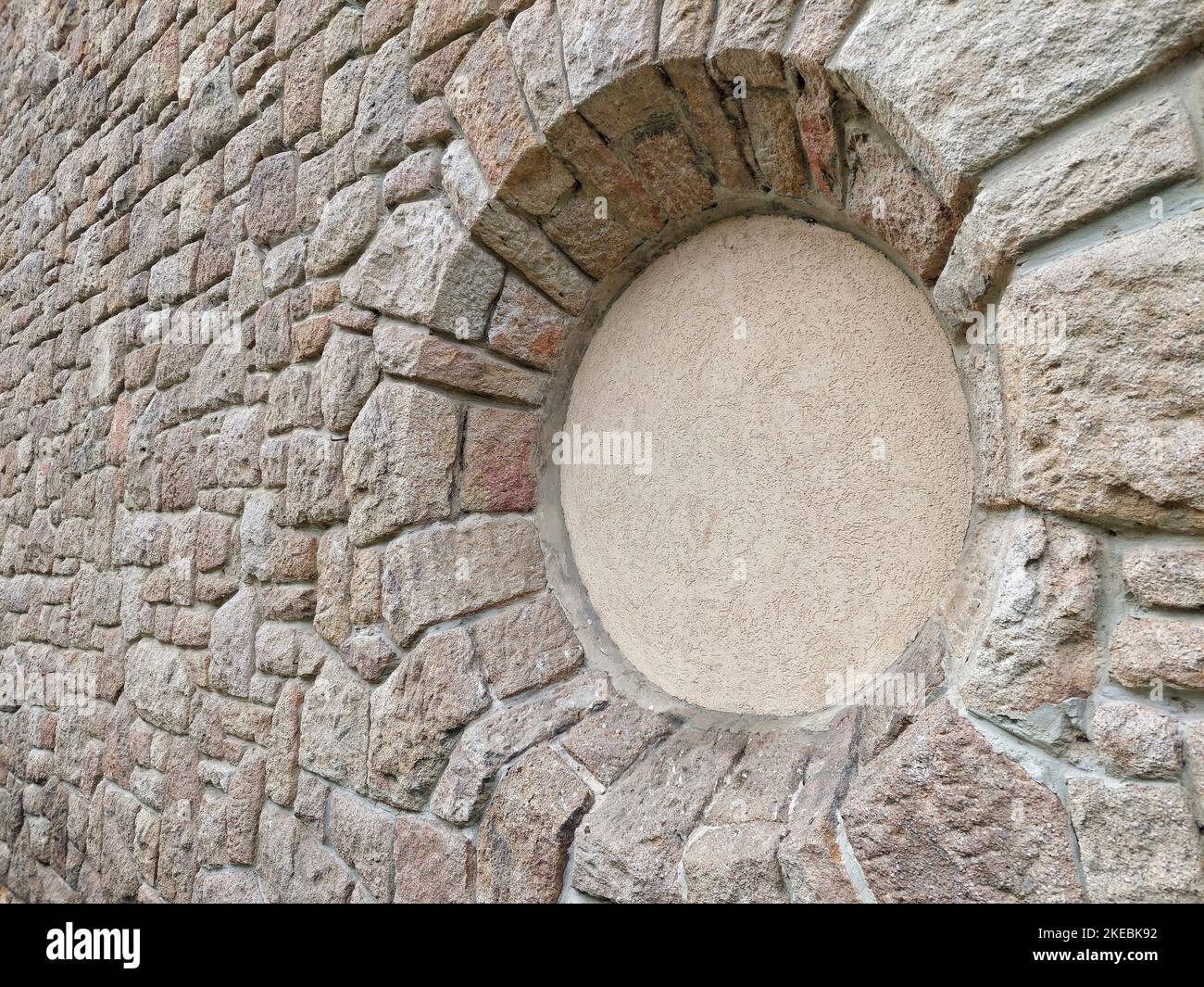 Round blind window in the stone wall of the church Stock Photo - Alamy