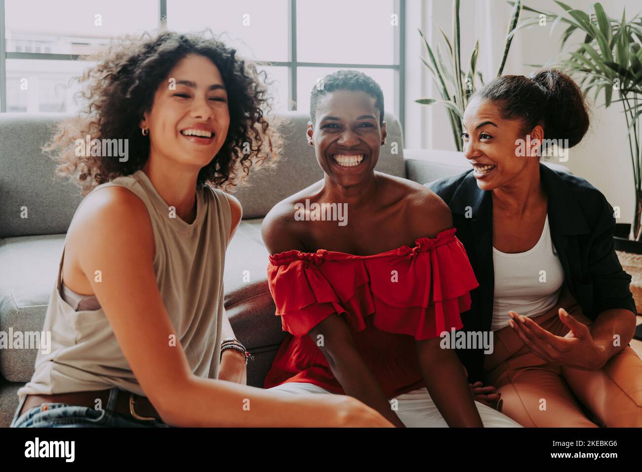 Happy beautiful hispanic south american and black women meeting indoors ...