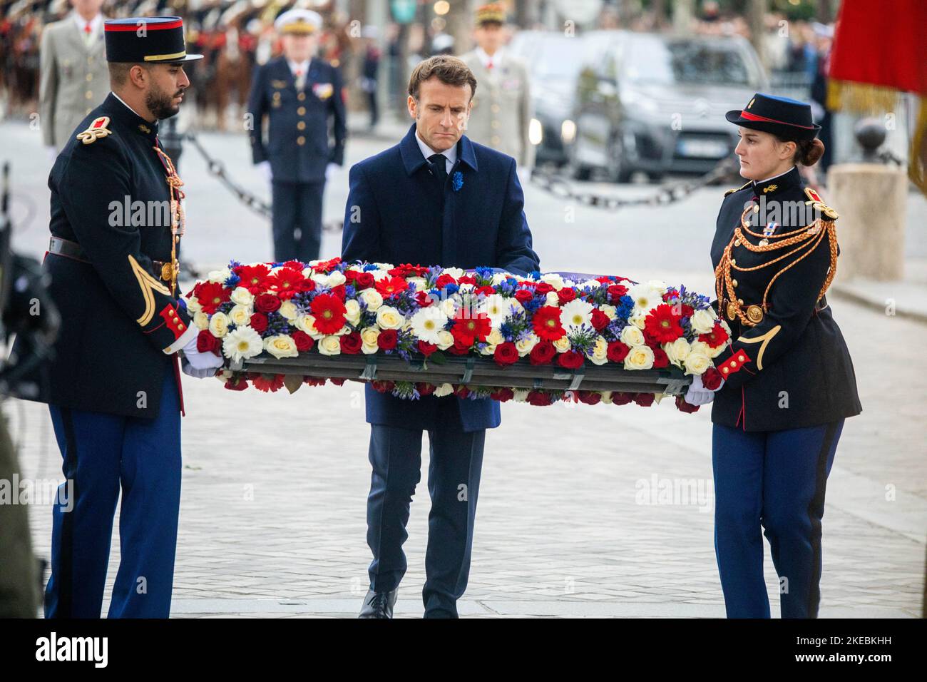 French President Emmanuel Macron lays a wreath of flowers during a ...