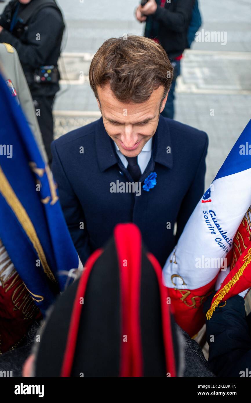 French President Emmanuel Macron lays a wreath of flowers during a ...