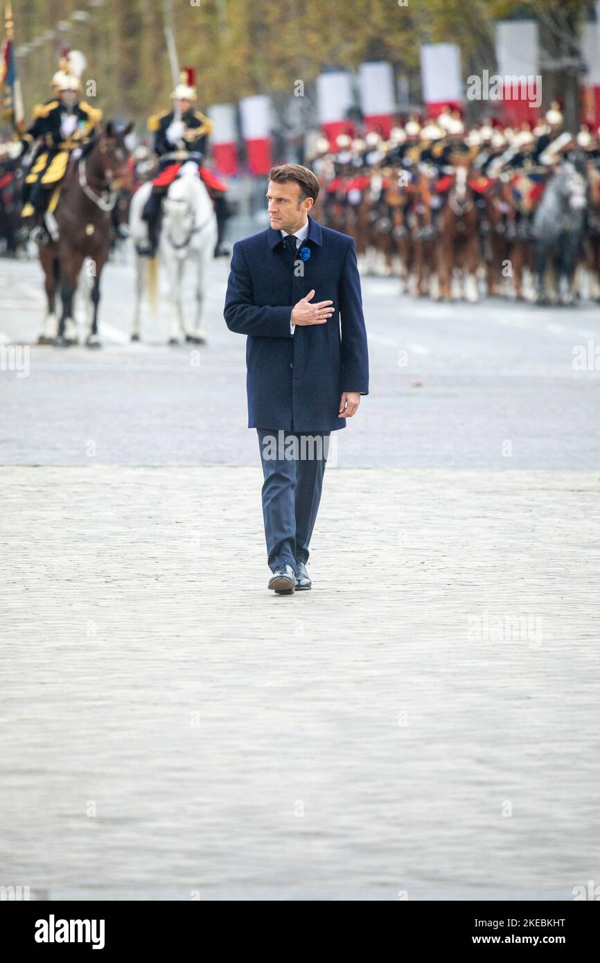 French President Emmanuel Macron lays a wreath of flowers during a ...