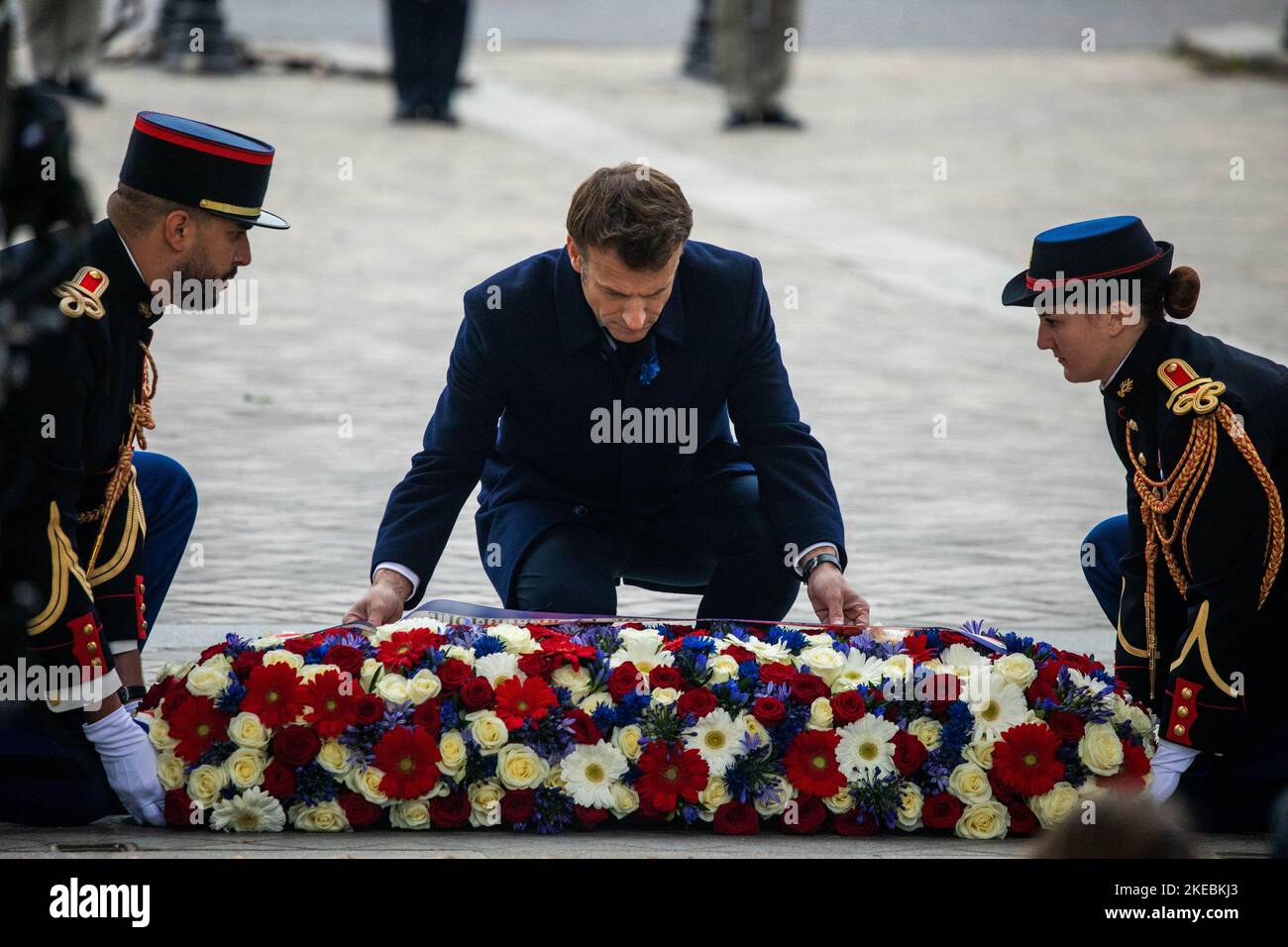 French President Emmanuel Macron lays a wreath of flowers during a ...