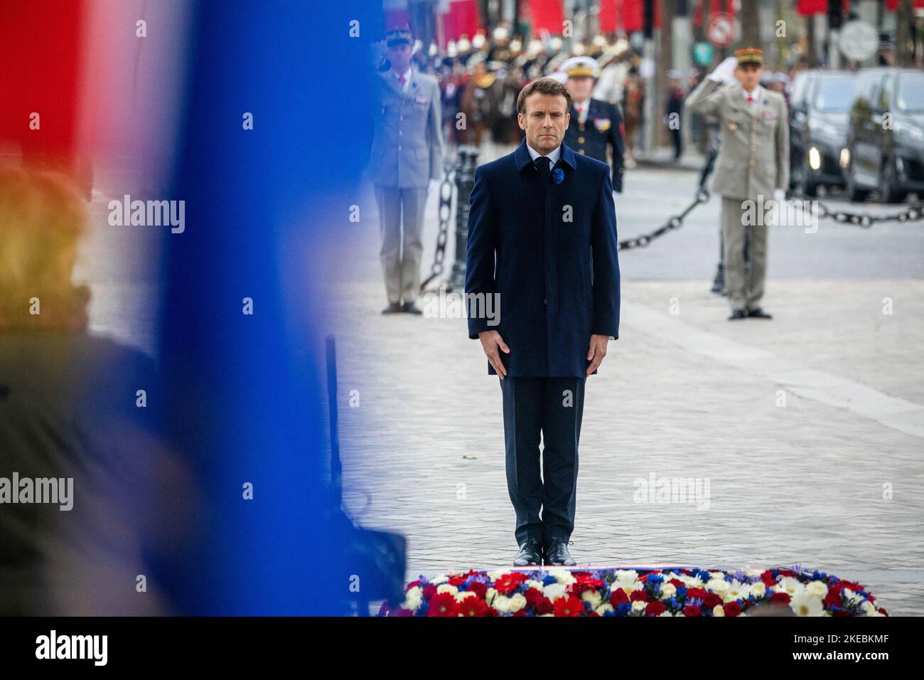 French President Emmanuel Macron lays a wreath of flowers during a ...
