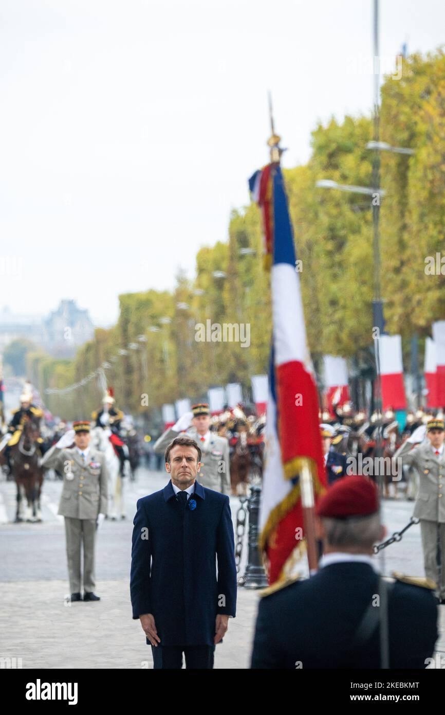 French President Emmanuel Macron lays a wreath of flowers during a ...