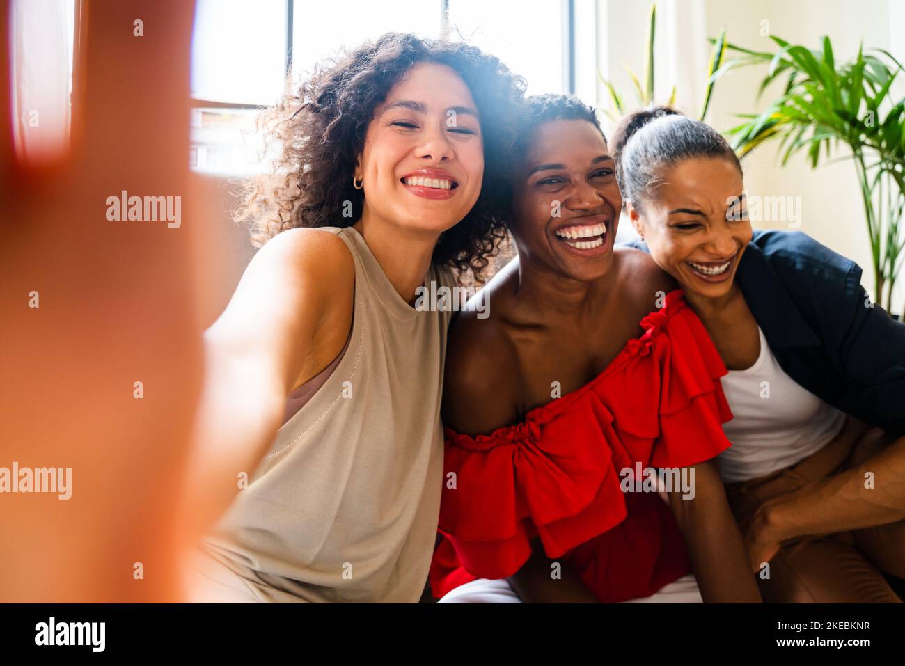 Happy beautiful hispanic south american and black women meeting indoors ...